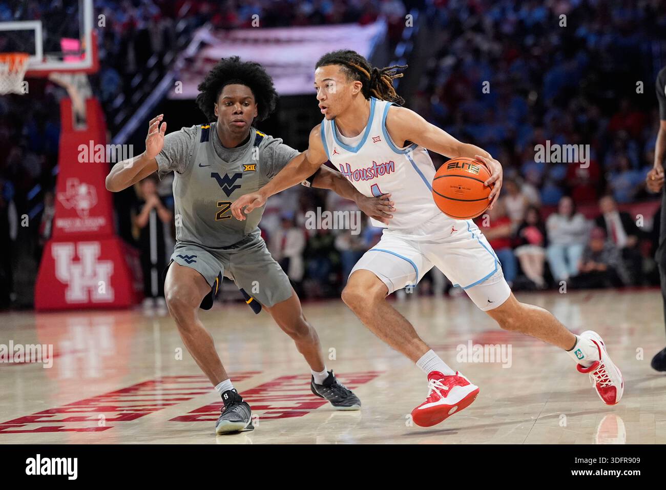 Houston's Kingston Flemings, right, drives toward the basket as West ...