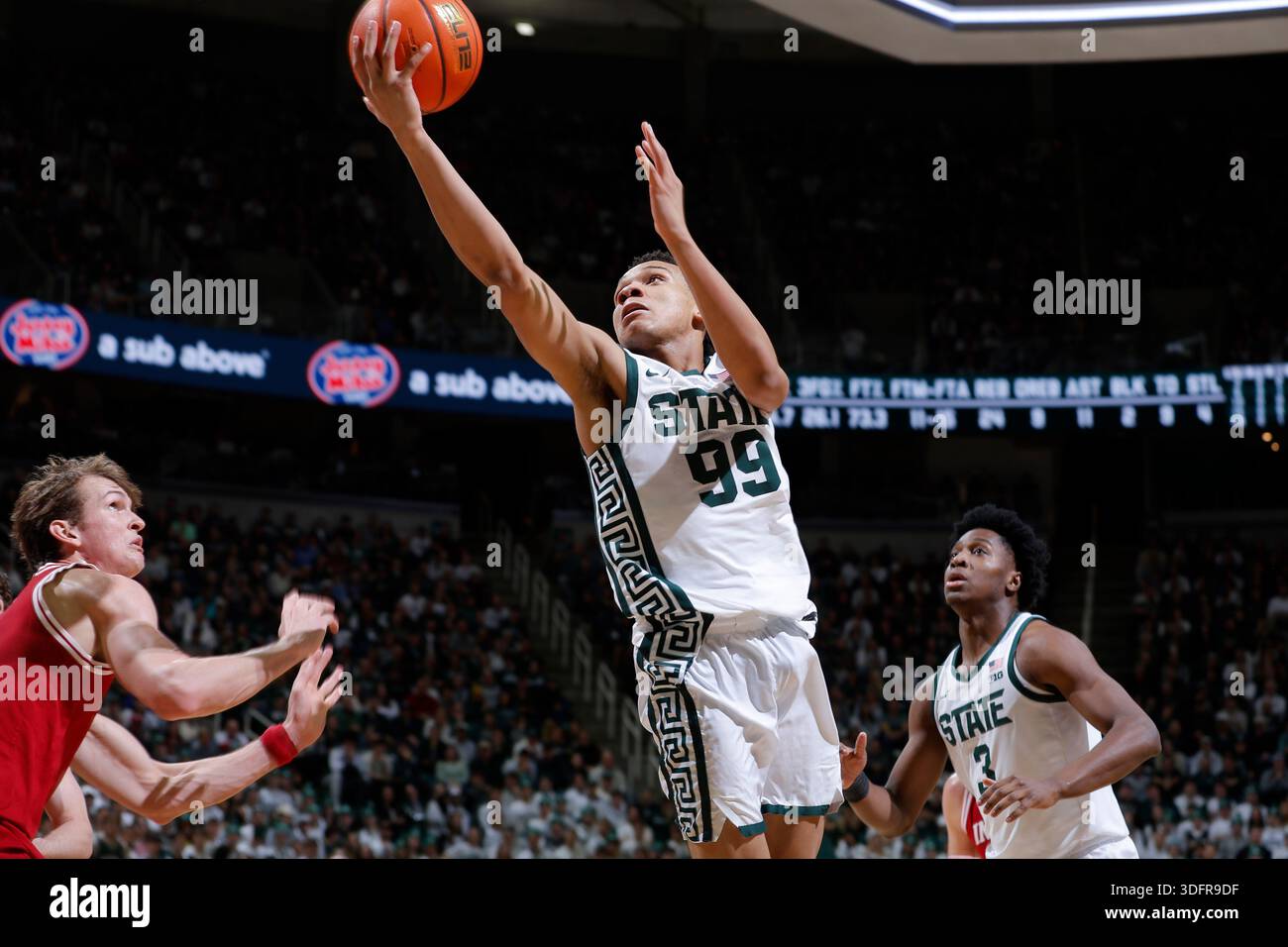 Michigan State guard Divine Ugochukwu (99) goes up for a layup against ...