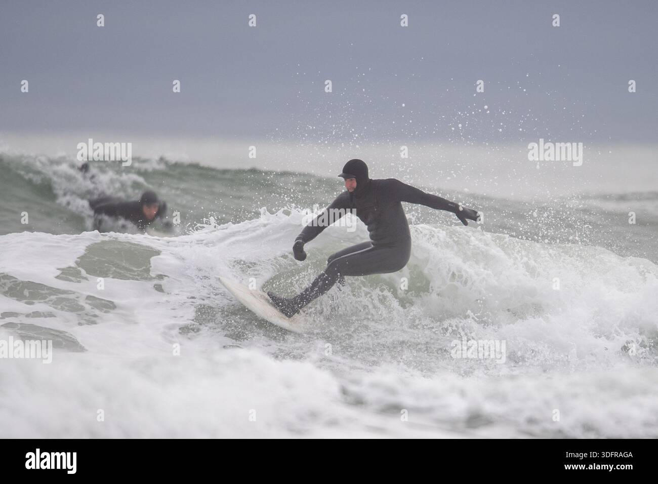 HAMPTON, NH - JANUARY 11: A surfer rides a wave on January 11, 2026, at ...
