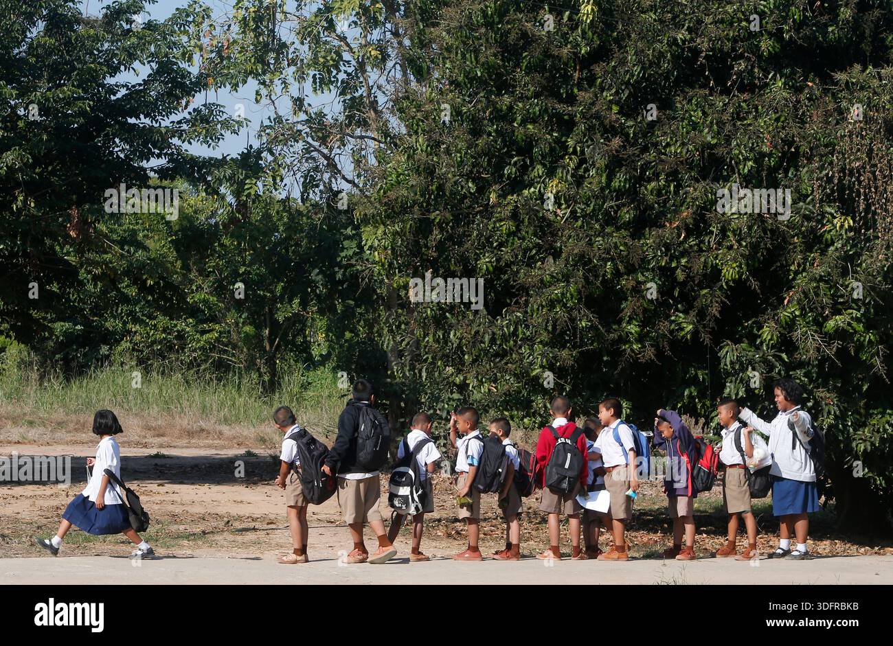 School children line up as they walk home from school. (Photo by ...