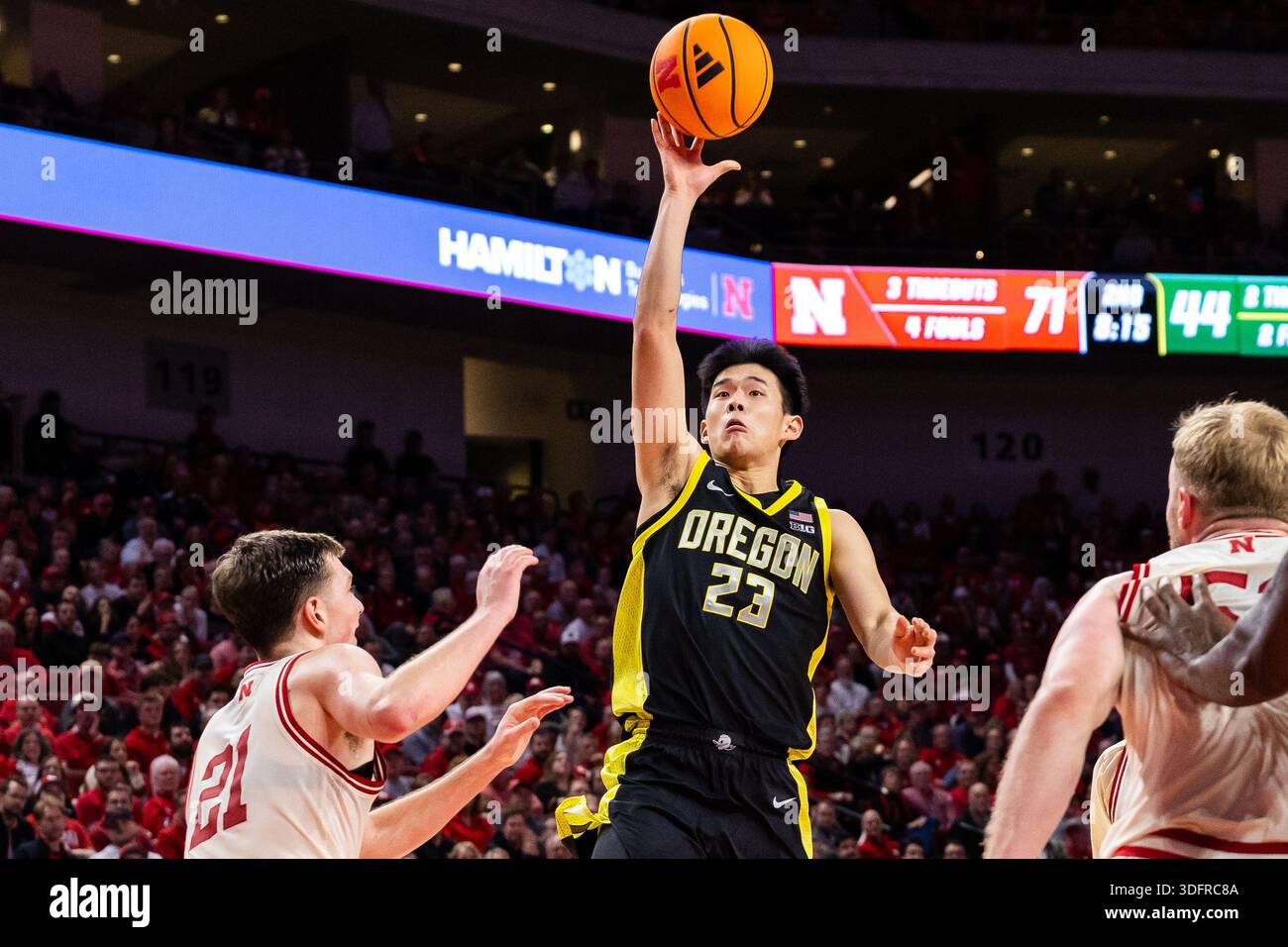 Oregon guard Wei Lin (23) shoots the ball against Nebraska forward ...