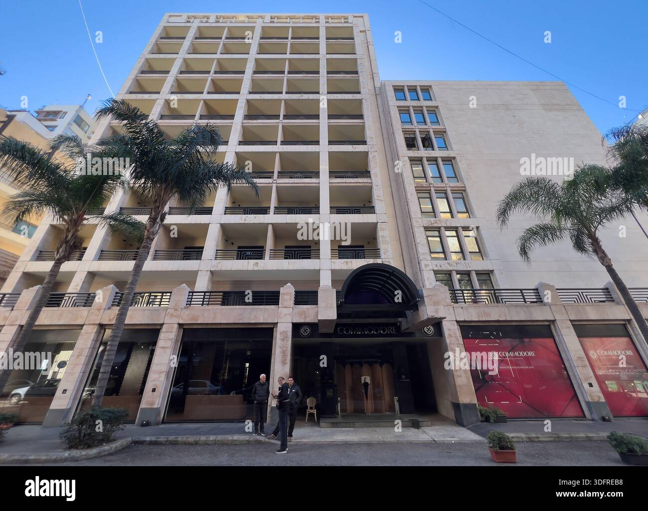 People stand outside the closed Commodore hotel, in Beirut, Lebanon ...