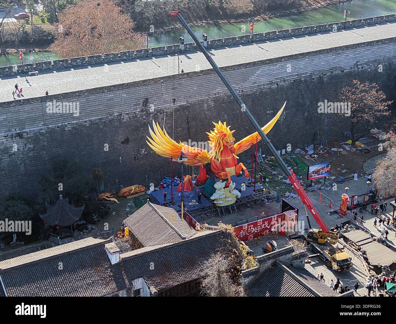 A giant flying horse lantern is installed under the city wall at ...