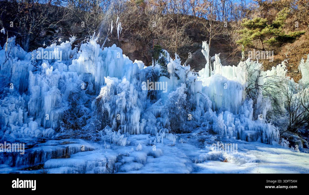 Tourists admire the spectacular ice waterfall scenery of Longtan Grand ...