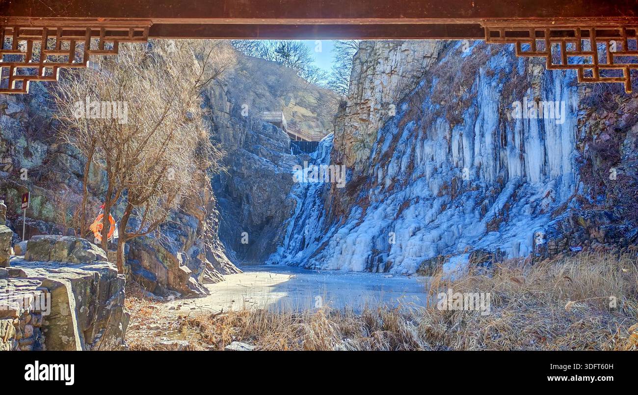 Tourists admire the spectacular ice waterfall scenery of Longtan Grand ...