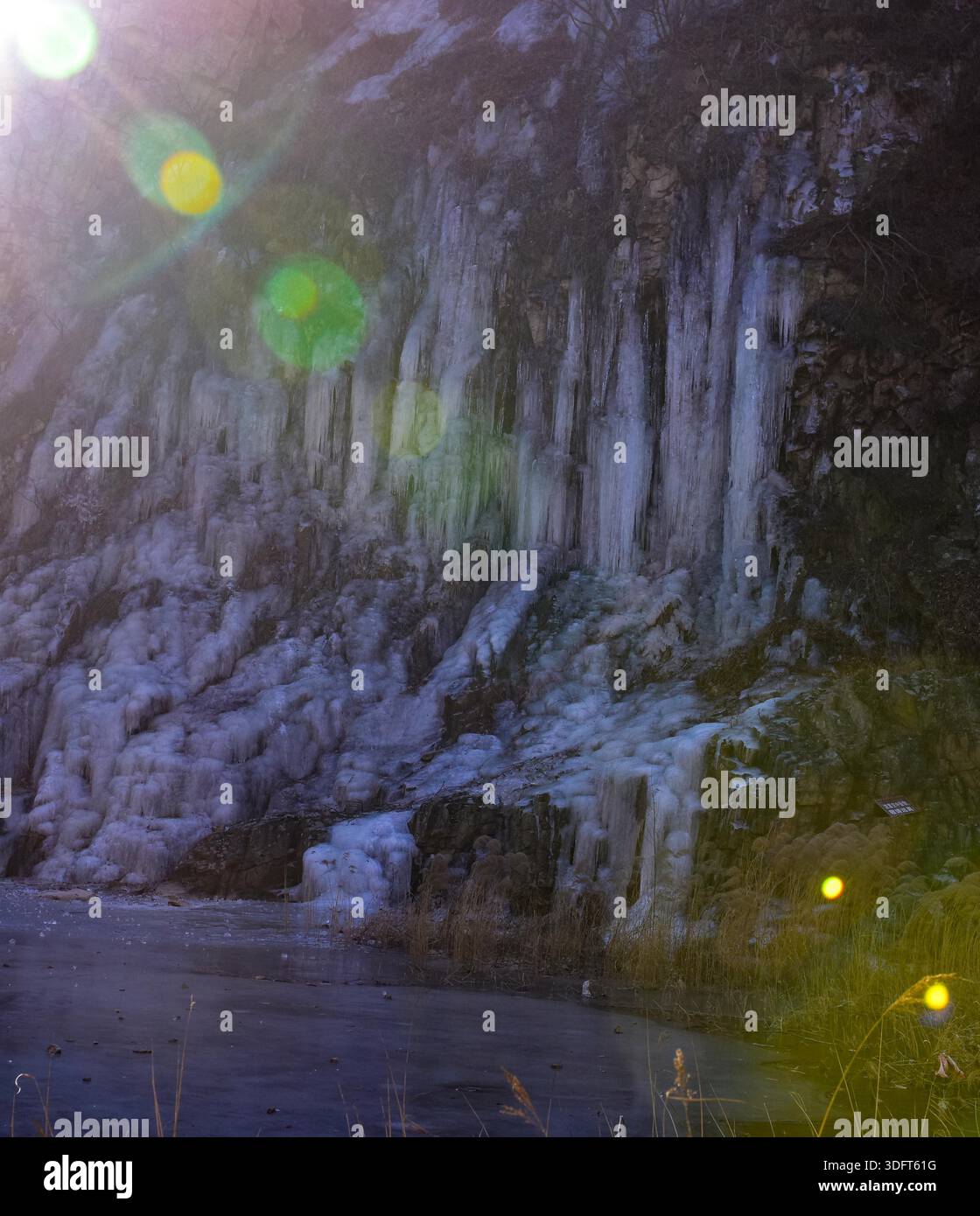 Tourists admire the spectacular ice waterfall scenery of Longtan Grand ...