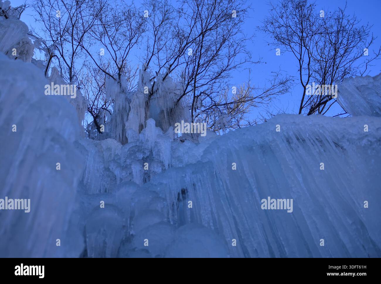 Tourists admire the spectacular ice waterfall scenery of Longtan Grand ...