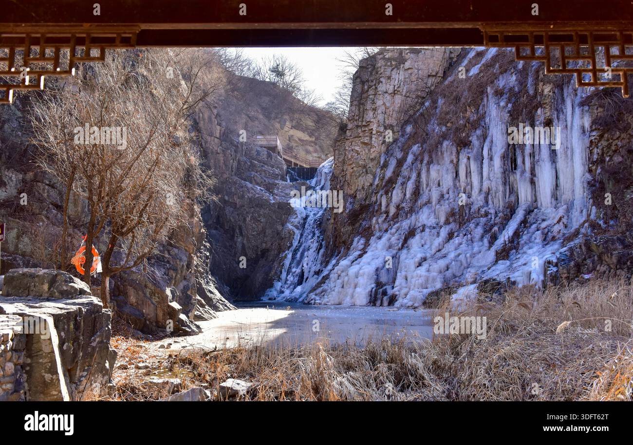 Tourists admire the spectacular ice waterfall scenery of Longtan Grand ...