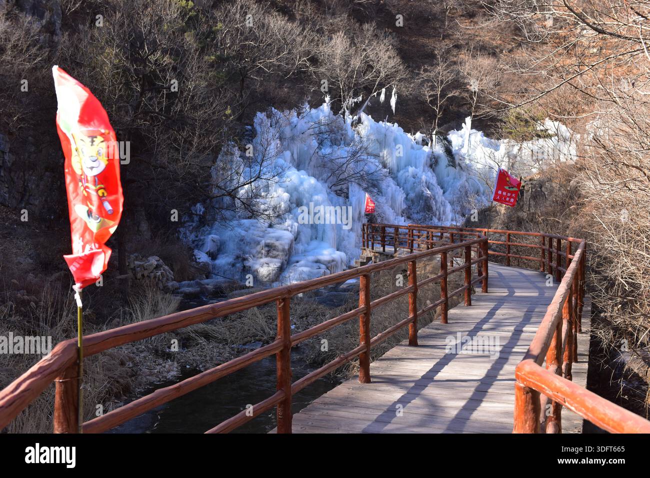 Tourists admire the spectacular ice waterfall scenery of Longtan Grand ...