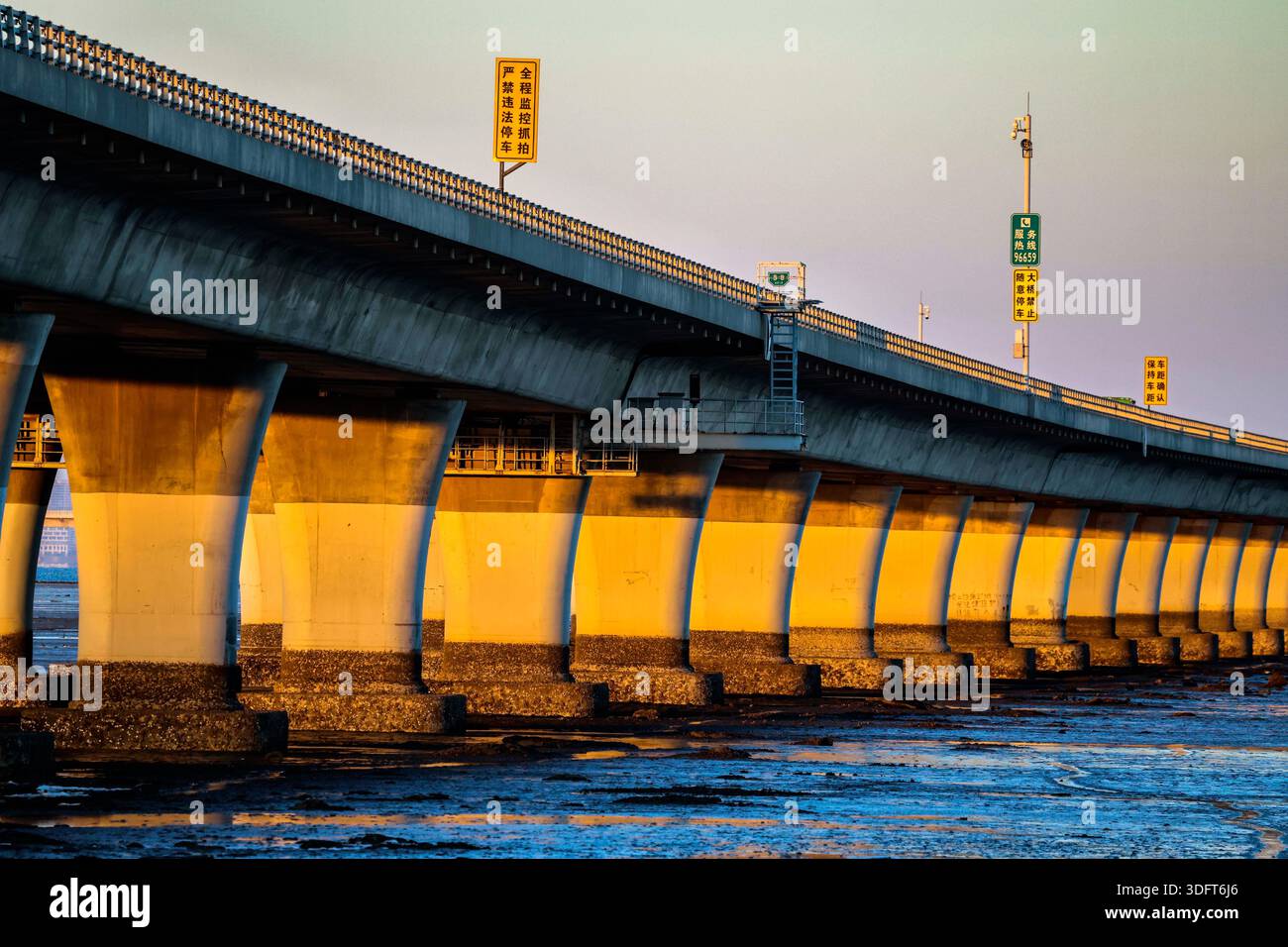 Golden light pierces through Jiaozhou Bay Bridge in West Coast New Area ...