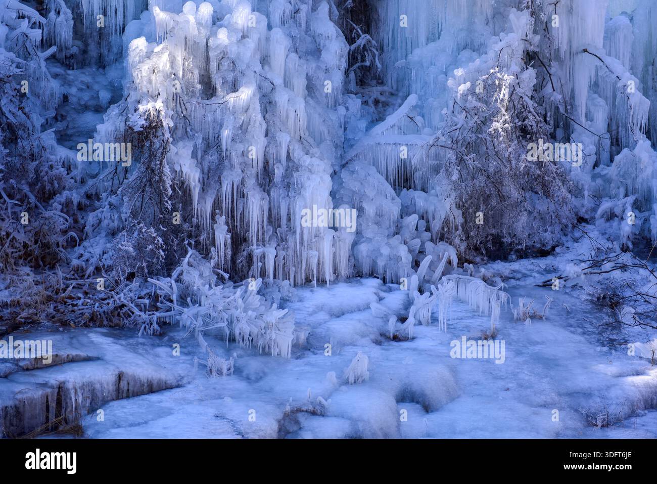 Tourists admire the spectacular ice waterfall scenery of Longtan Grand ...
