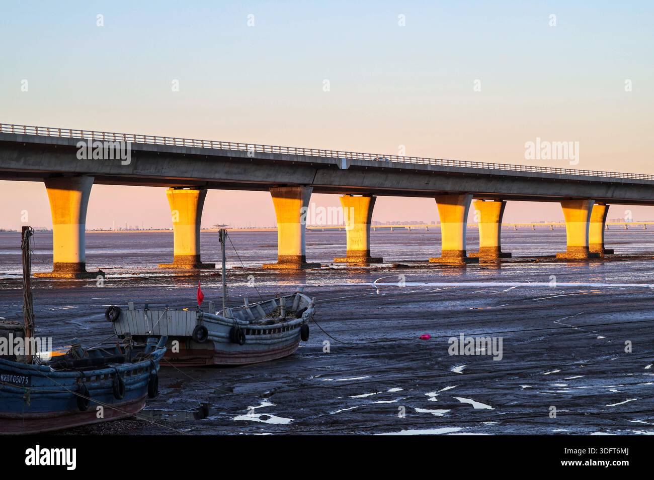 Golden light pierces through Jiaozhou Bay Bridge in West Coast New Area ...