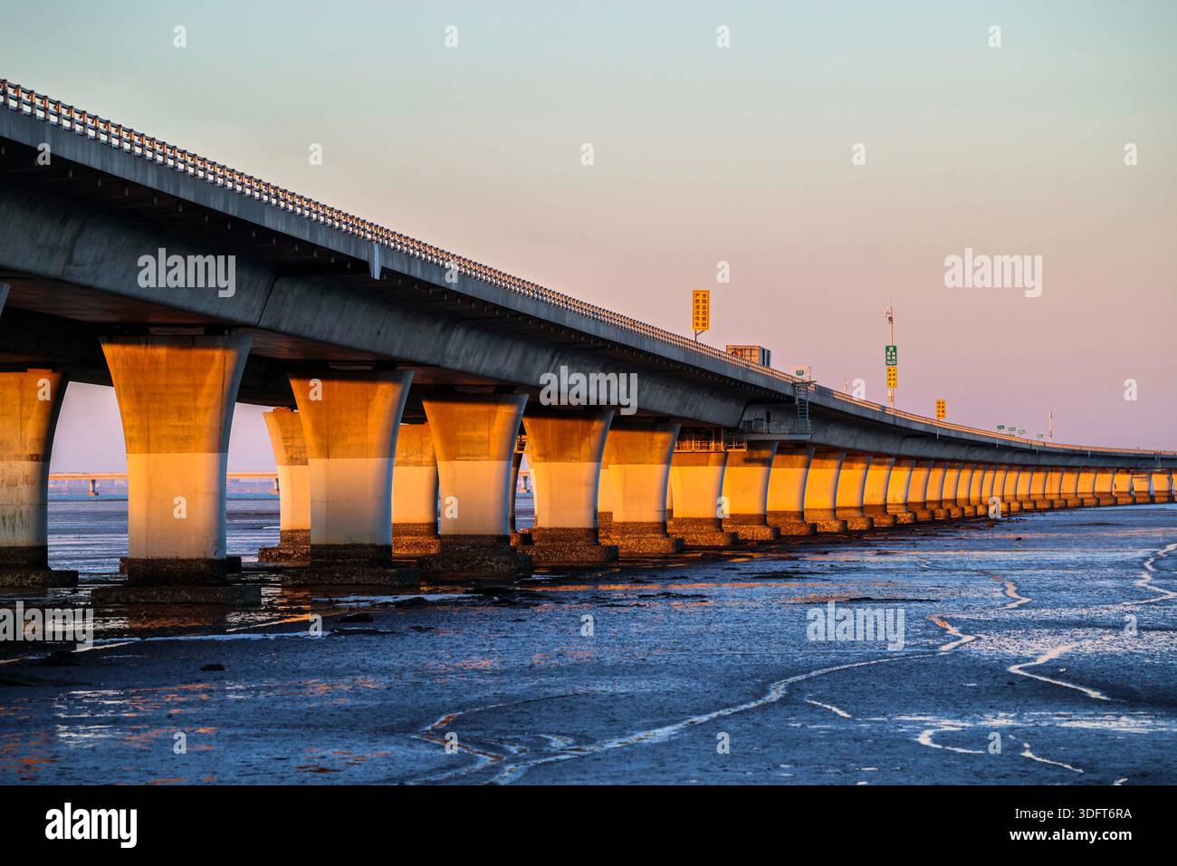 Golden light pierces through Jiaozhou Bay Bridge in West Coast New Area ...