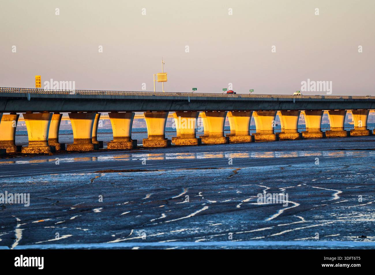 Golden light pierces through Jiaozhou Bay Bridge in West Coast New Area ...