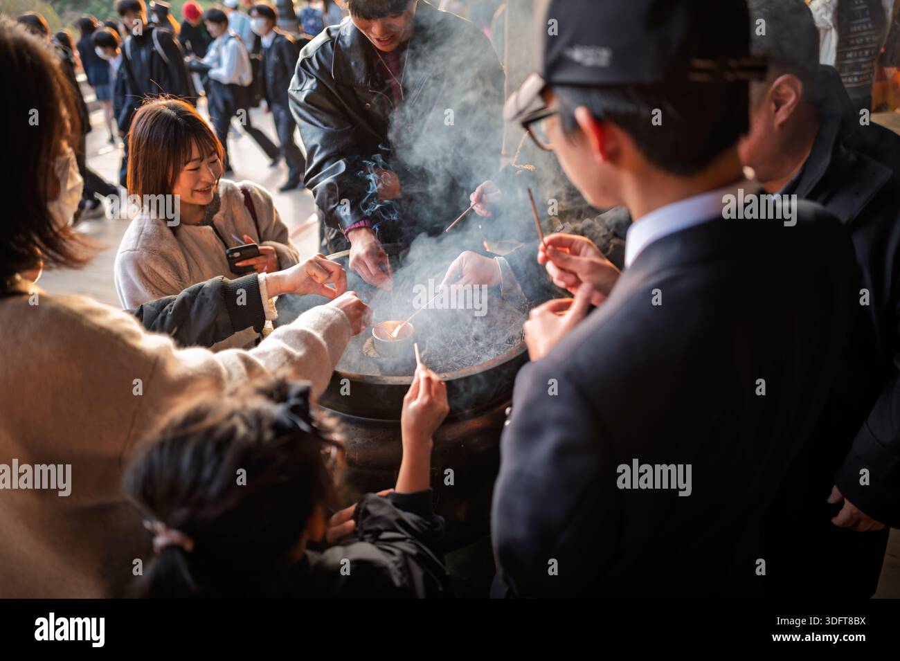 Kyoto, Japan - December 8, 2025: Tourists with smile burned the small ...