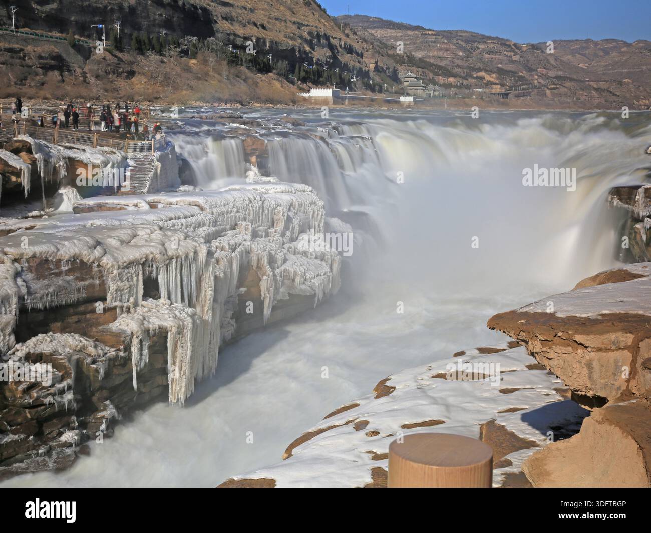 Tourists visit the Hukou Waterfall scenic area in Linfen City, north ...