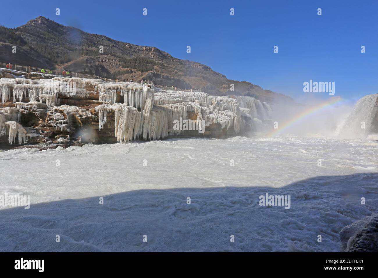 Tourists visit the Hukou Waterfall scenic area in Linfen City, north ...