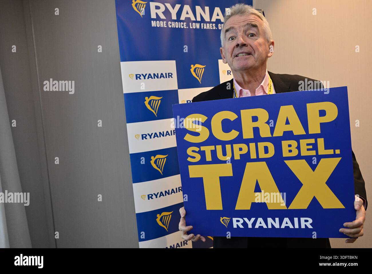 Ryanair CEO Michael O'Leary poses with a slogan at a press conference ...