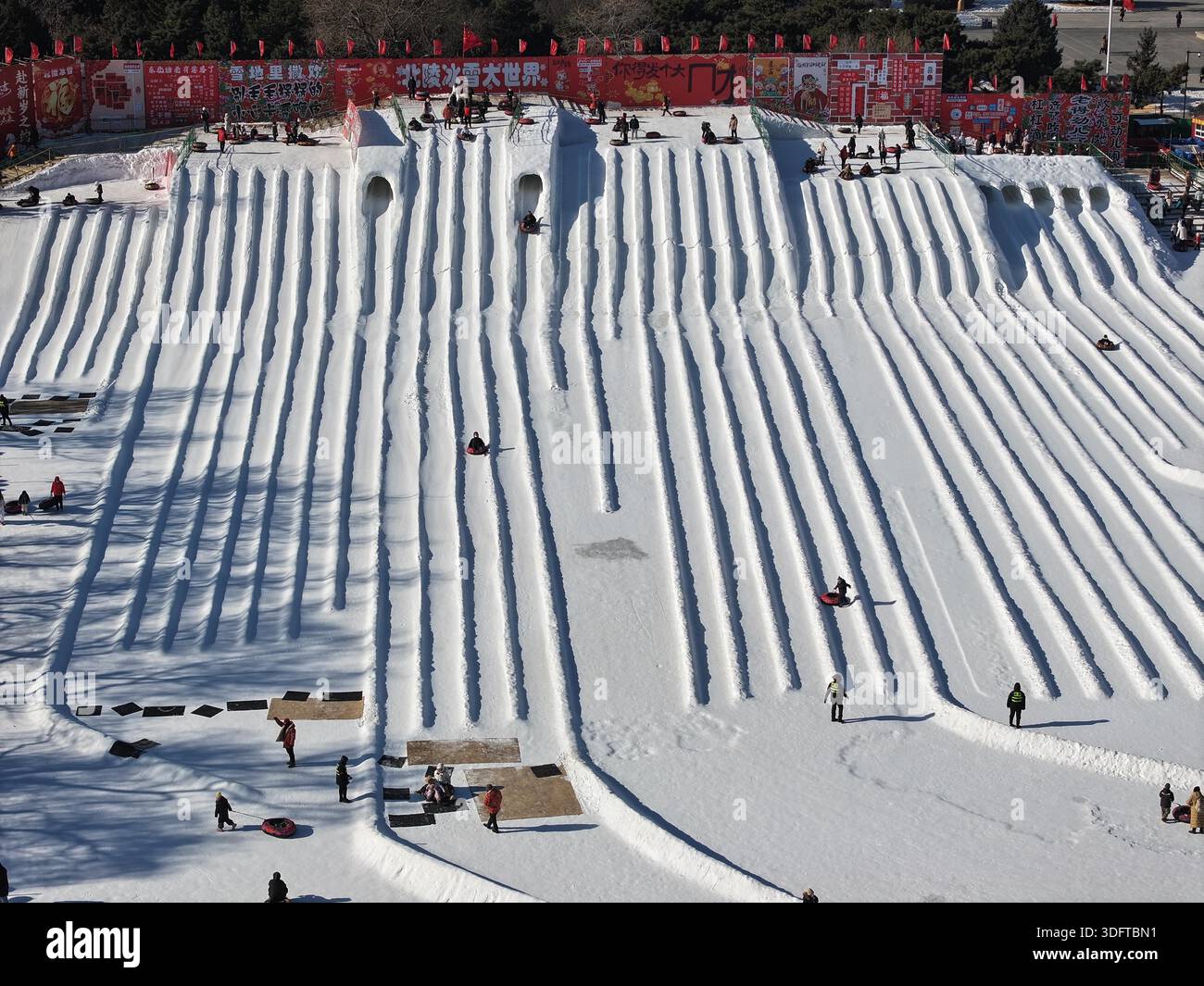 Aerial photo shows visitors enjoying winter sports at Beiling Park in ...