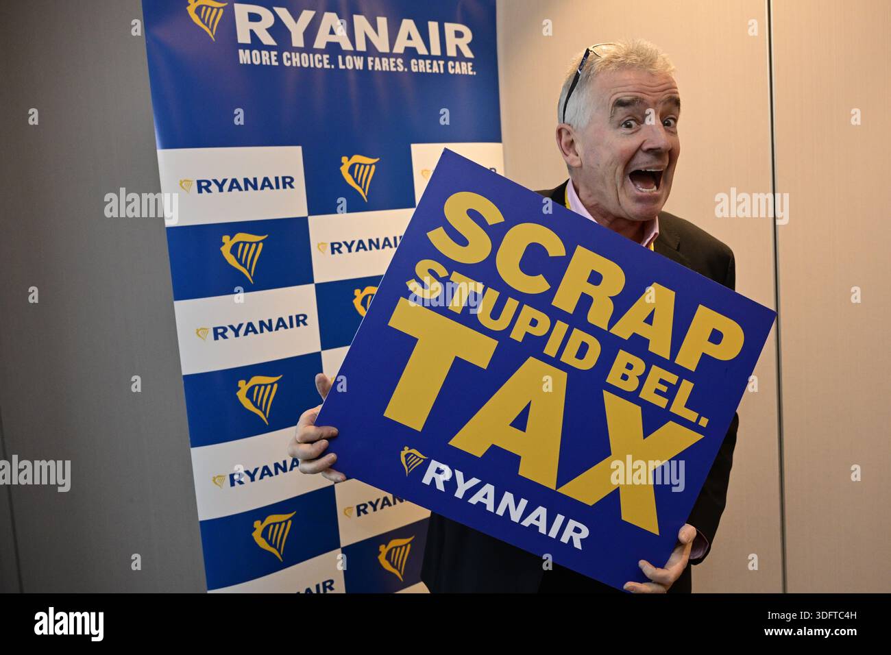 Ryanair CEO Michael O'Leary poses with a slogan at a press conference ...