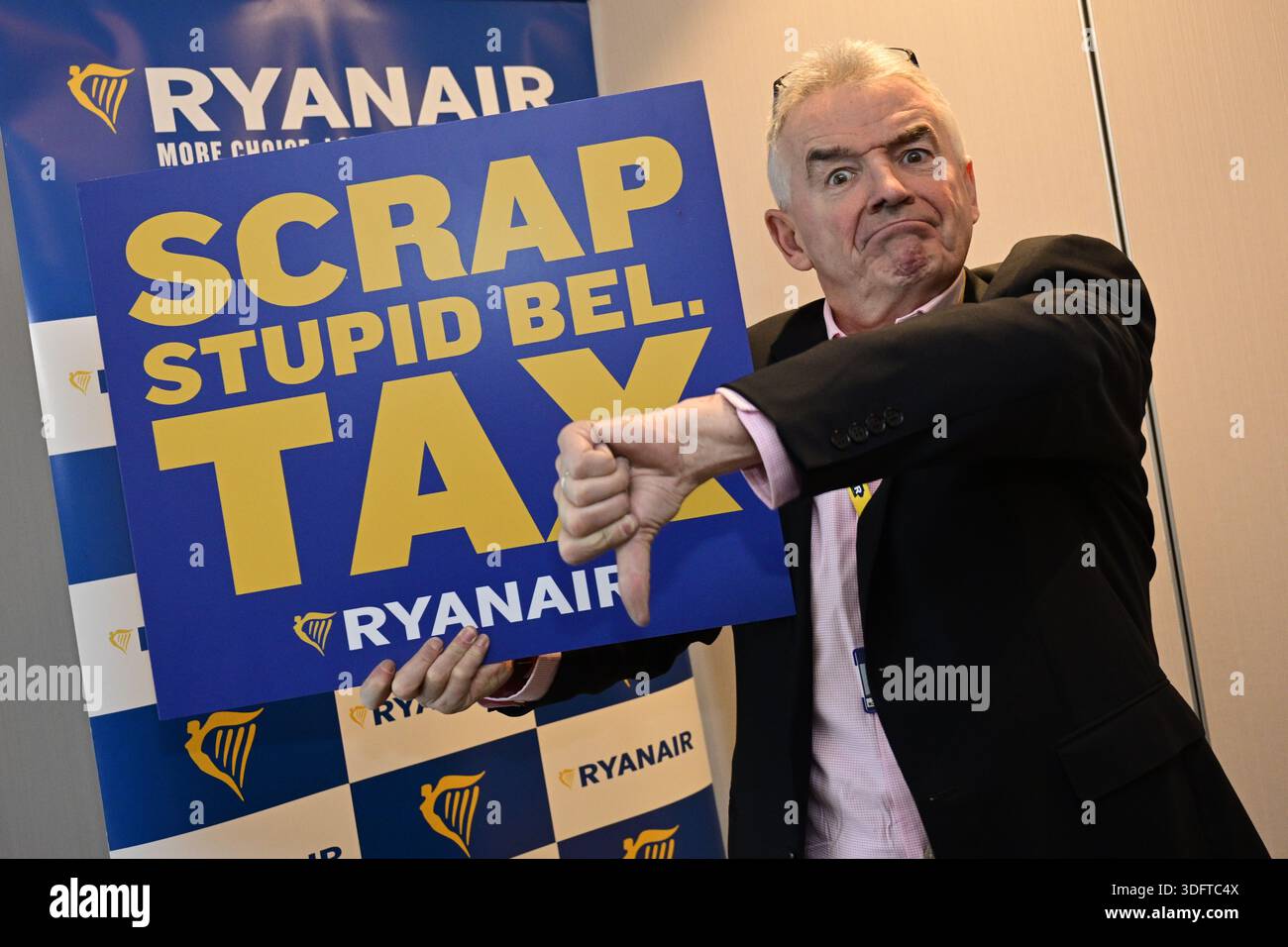 Ryanair CEO Michael O'Leary poses with a slogan at a press conference ...