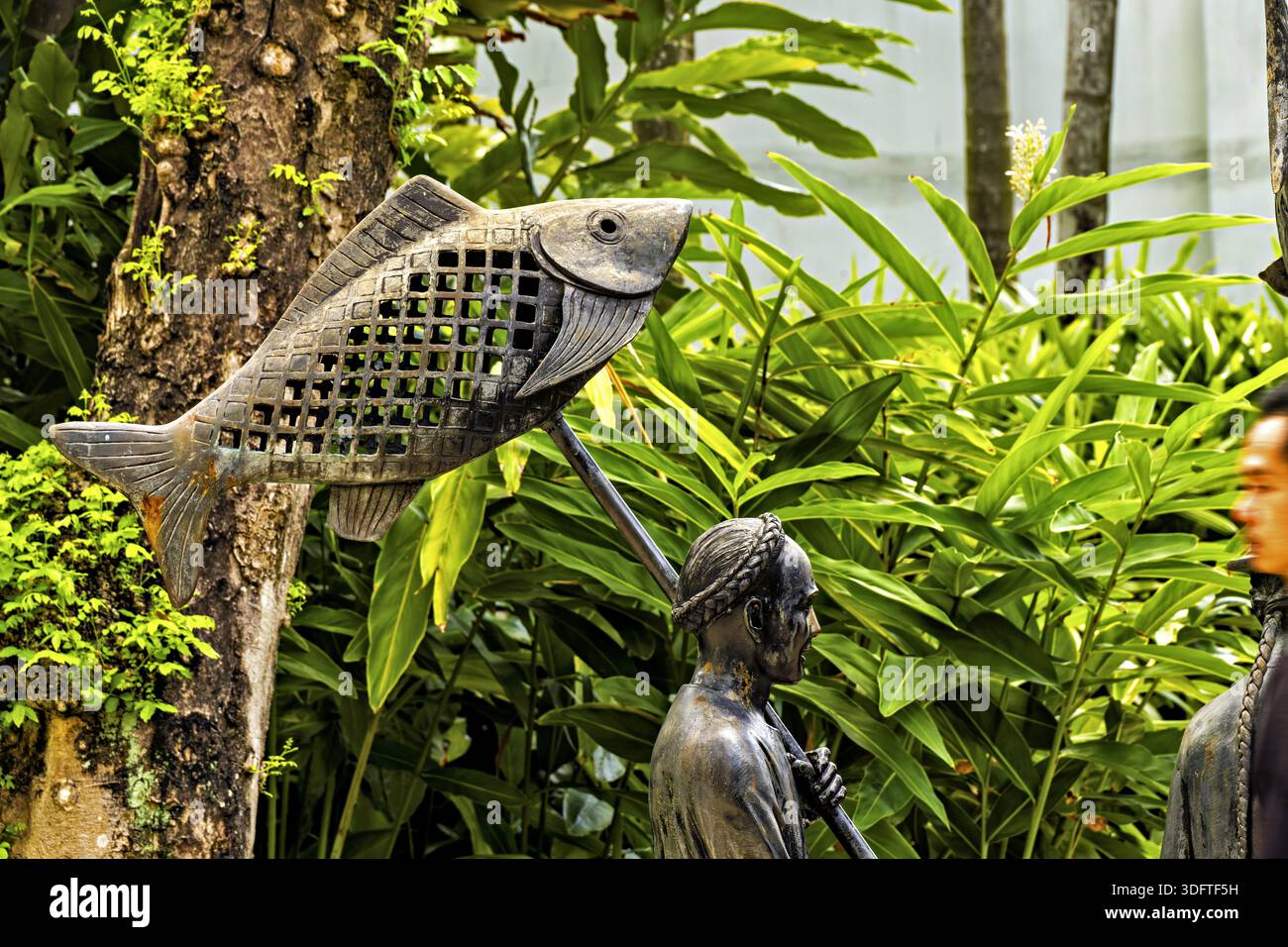 Outdoor sculpture in Singapore depicting a person in traditional attire ...