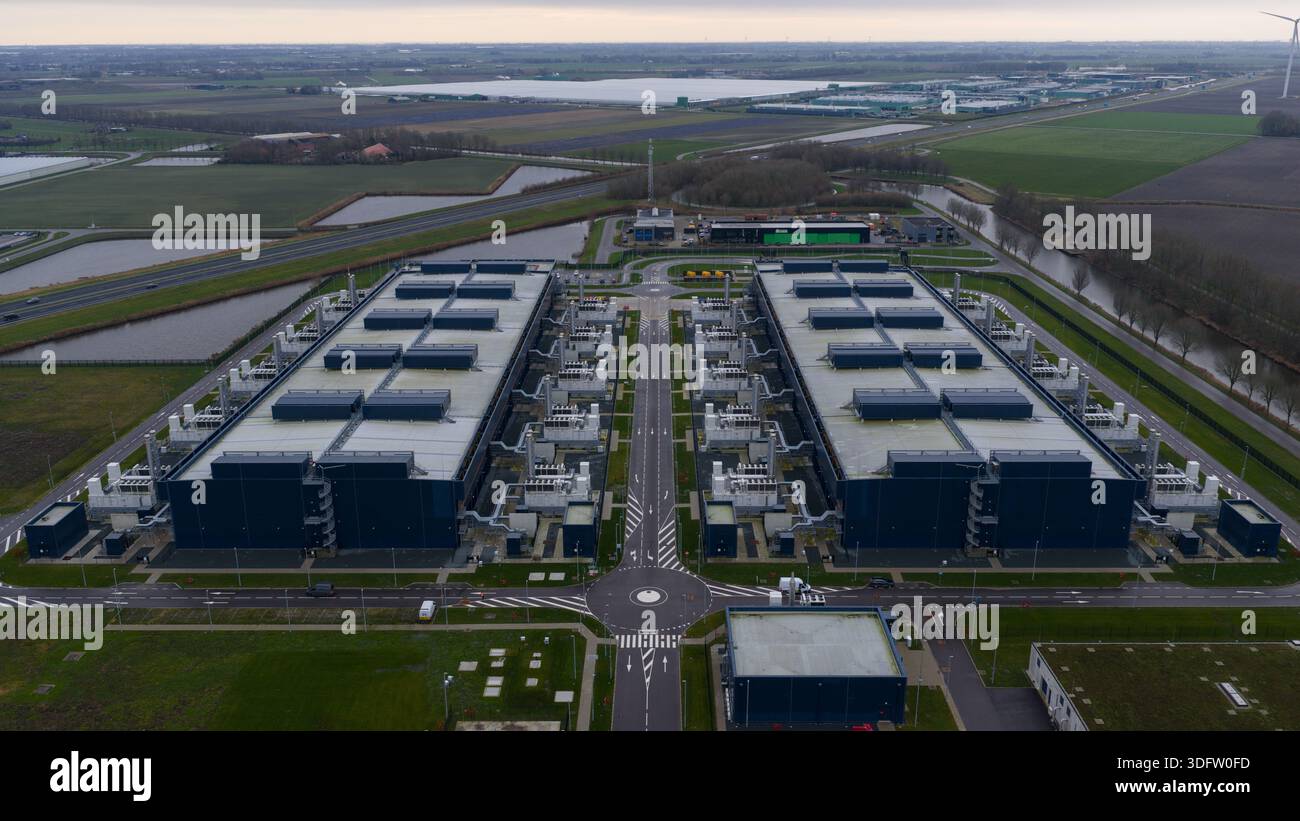 Aerial view of the vast data center complex with its dark roofs ...