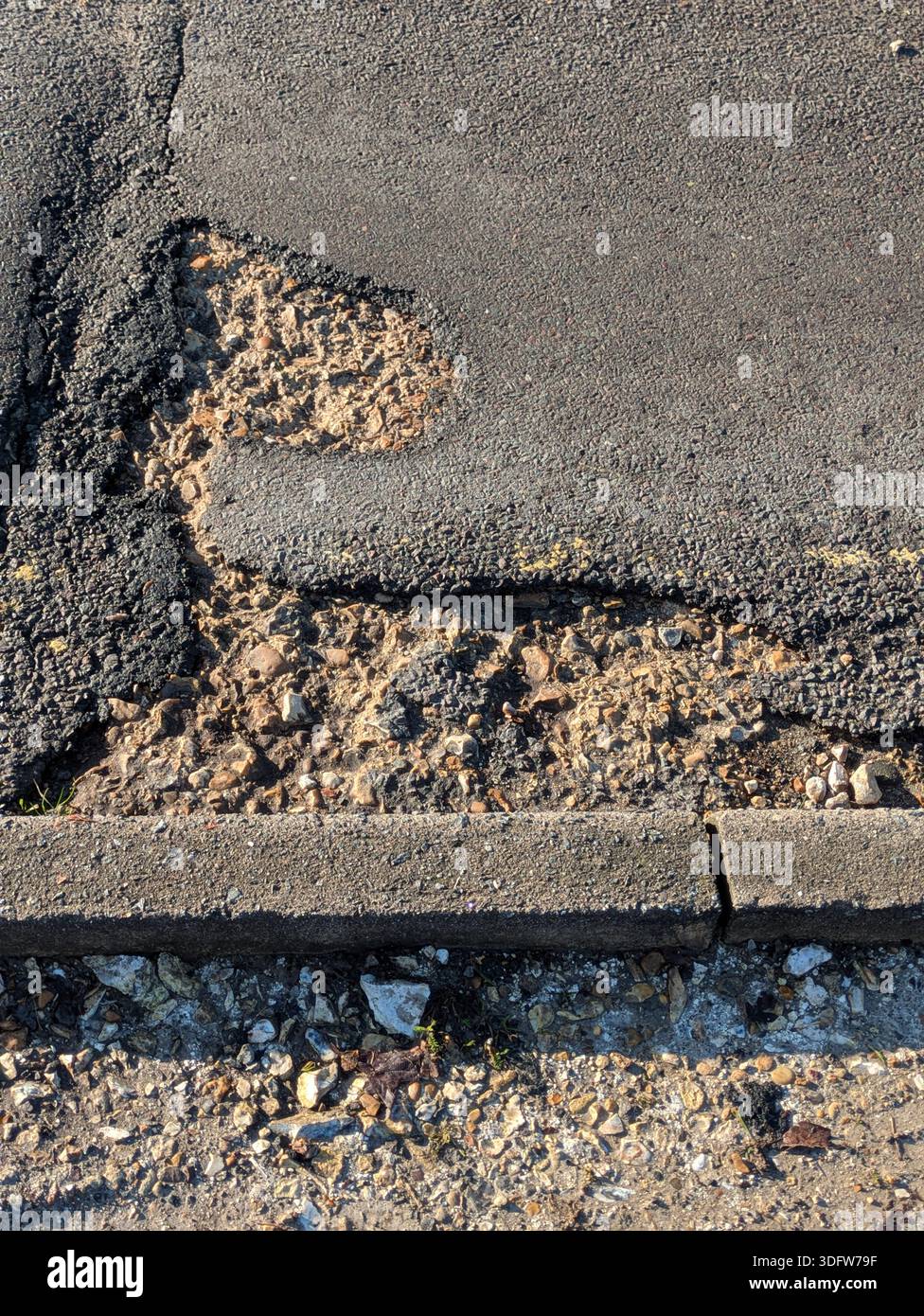Heavy deep pot holes potholes damaged tarmac on road dangerous travel ...
