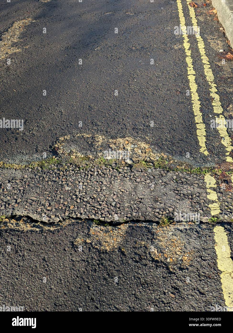 Heavy deep pot holes potholes damaged tarmac on road dangerous travel ...