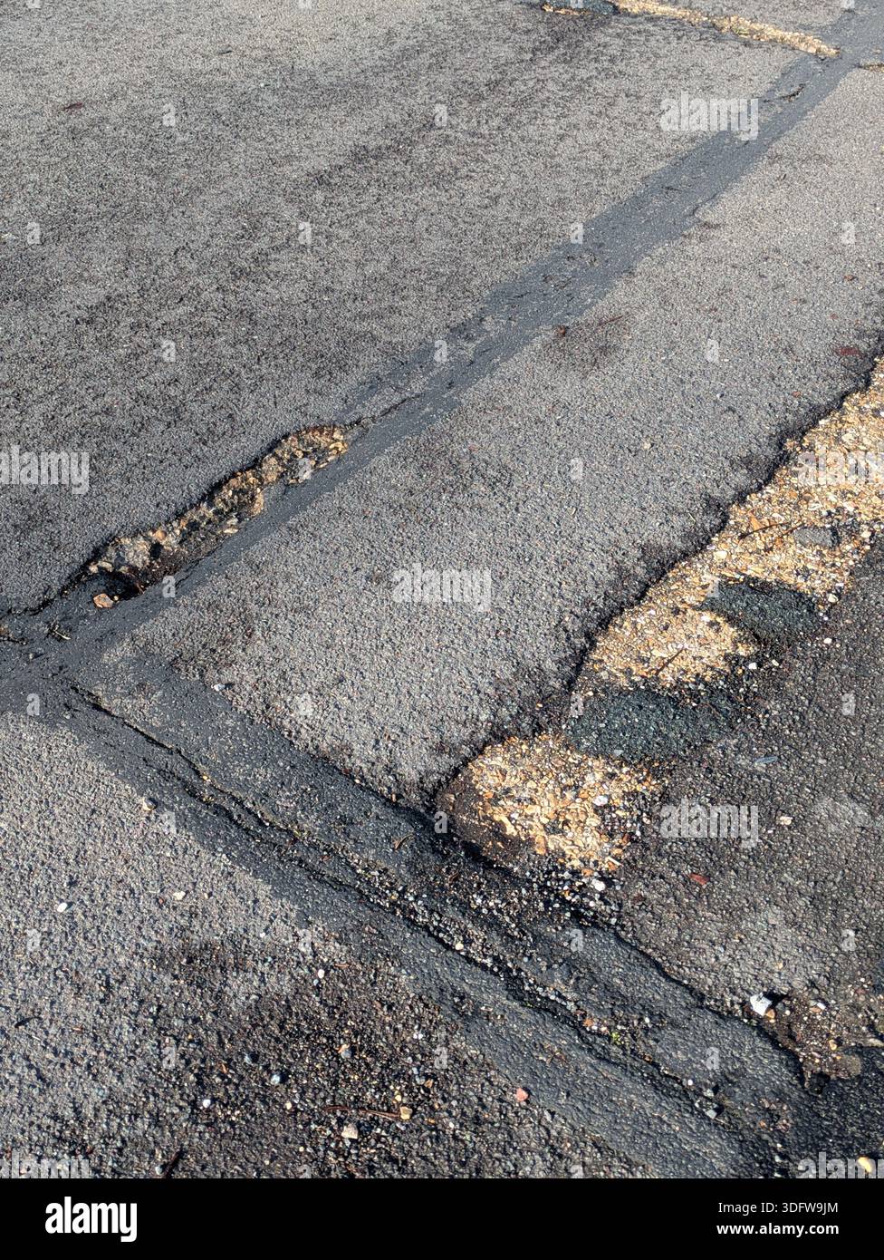 Heavy deep pot holes potholes damaged tarmac on road dangerous travel ...