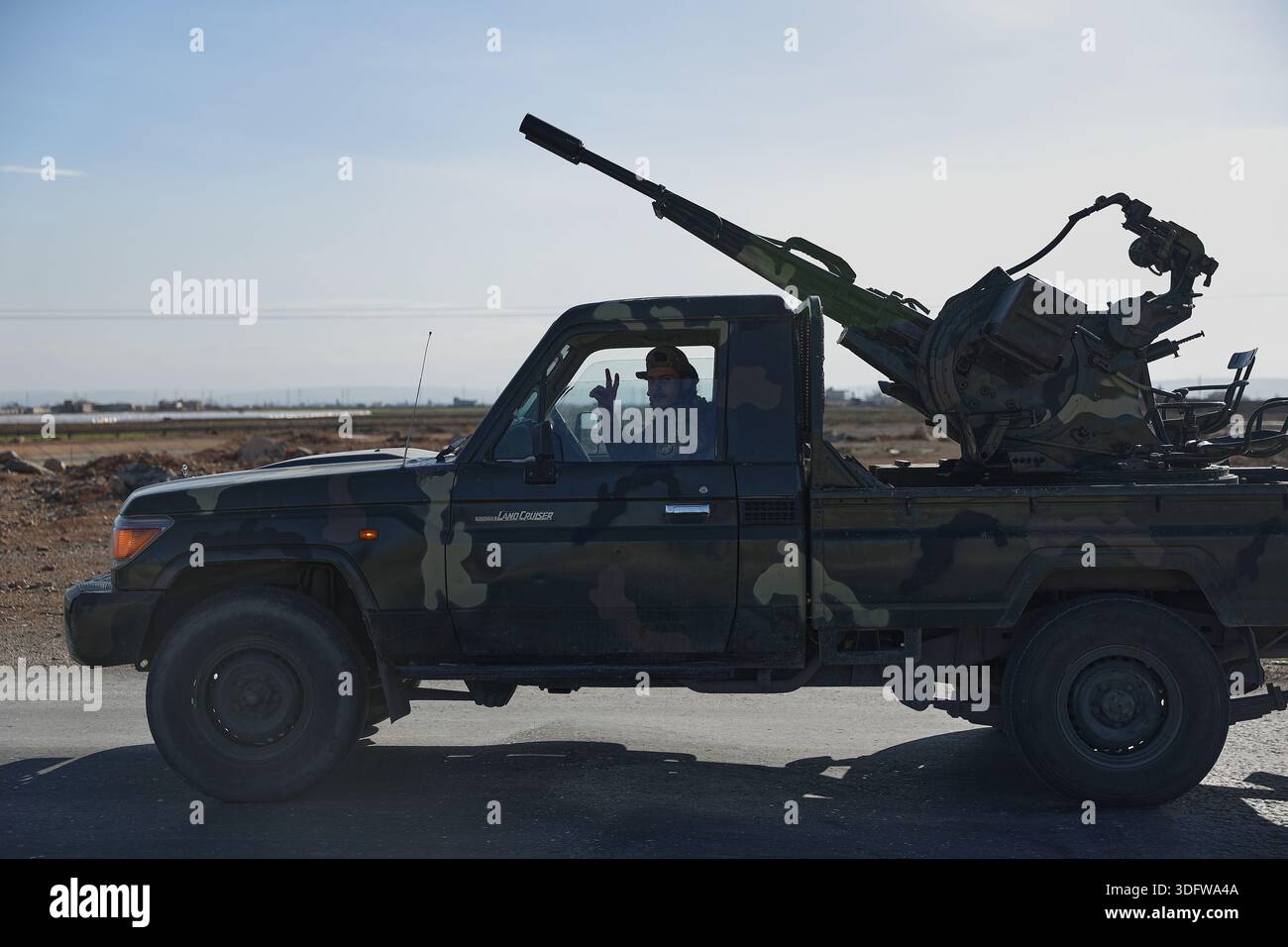 Syrian government soldier drive a vehicle with heavy machine gun on a ...