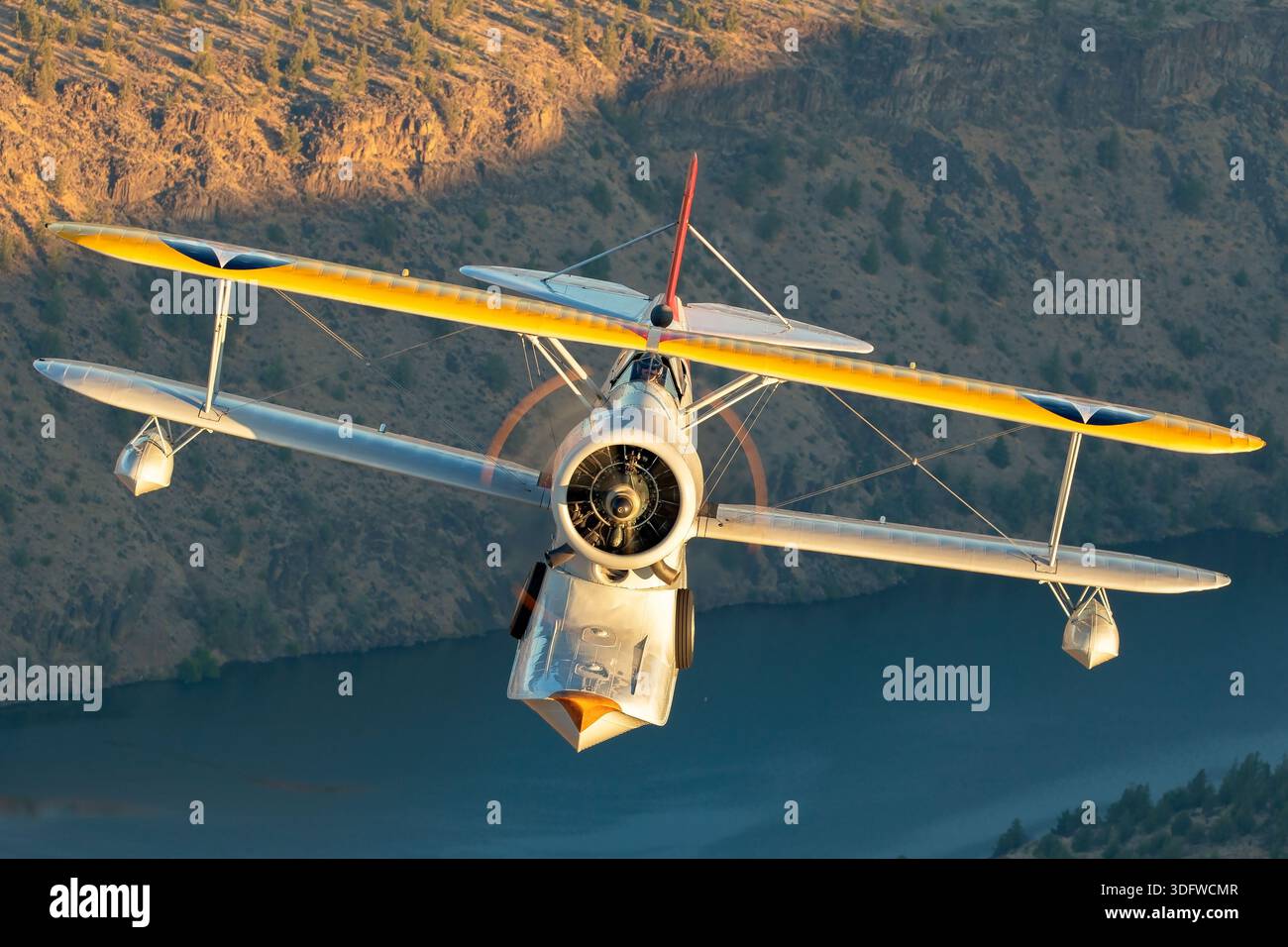 The image shows a Grumman J-2F-6 Duck amphibious biplane in flight ...