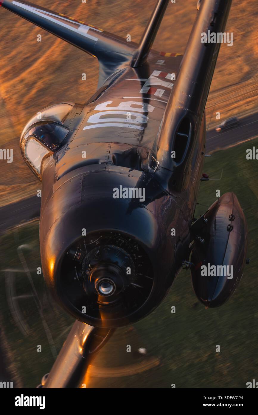 The image shows a Grumman F8F Bearcat warbird in flight, photographed ...