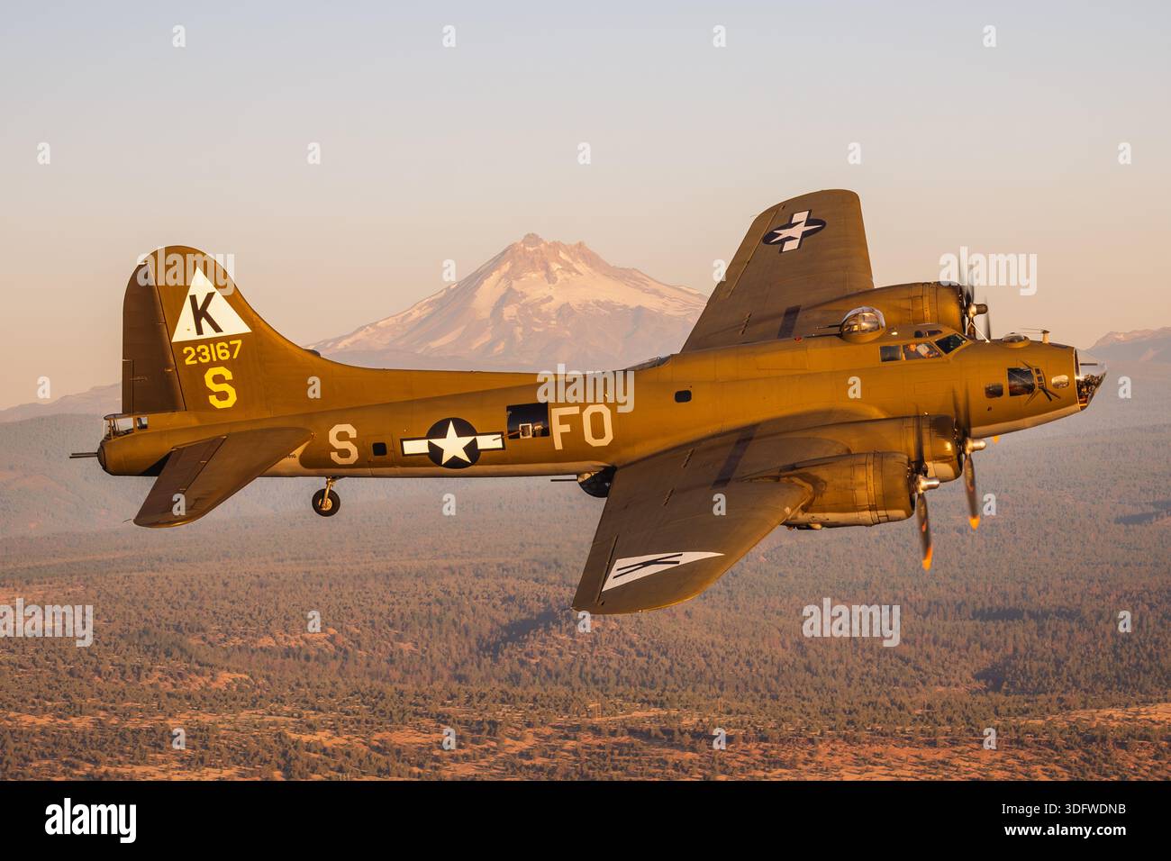 A Boeing B-17G Flying Fortress is photographed banking in flight during ...