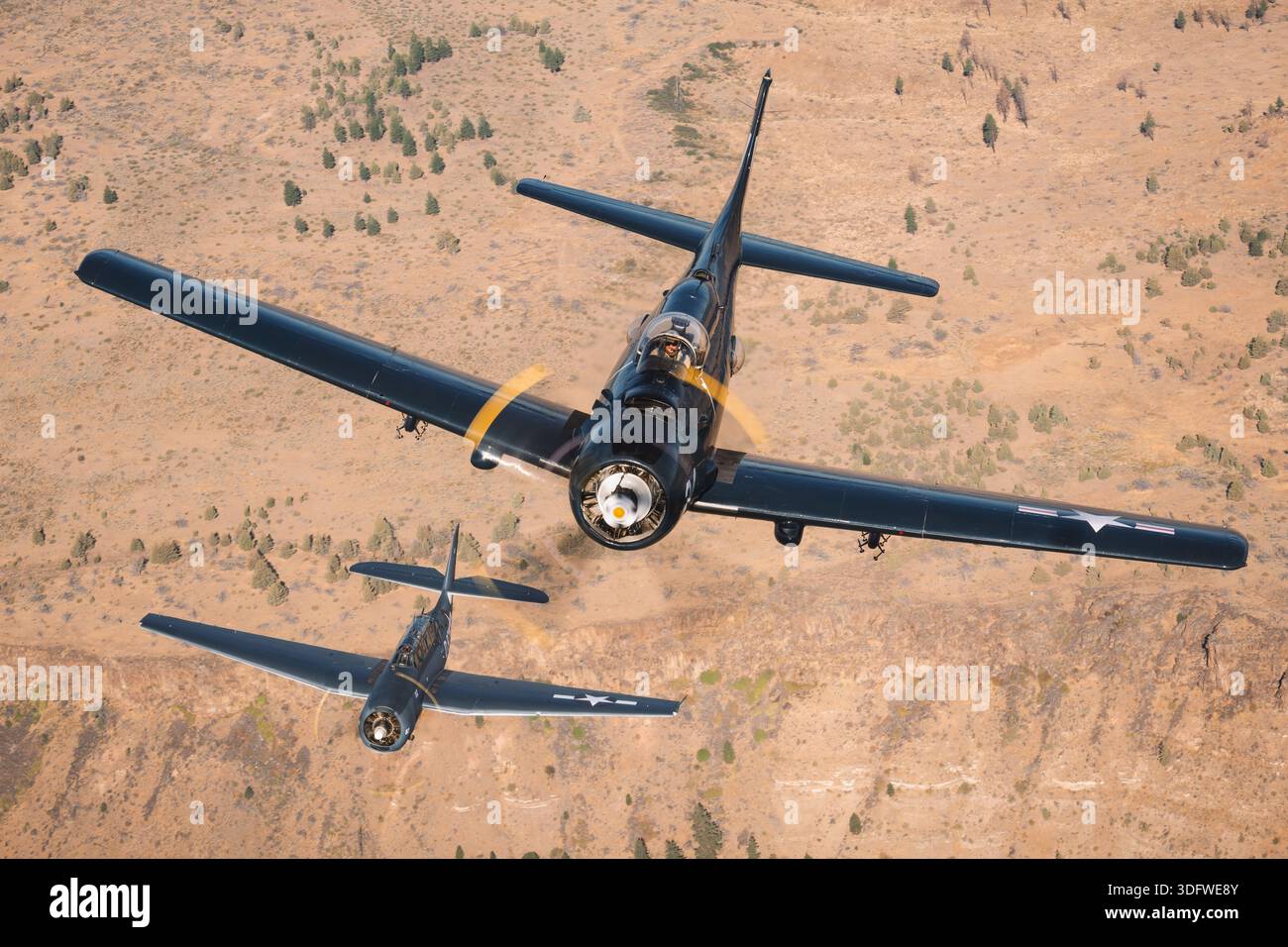 This photograph shows a Douglas AD-4W Skyraider flying alongside a ...