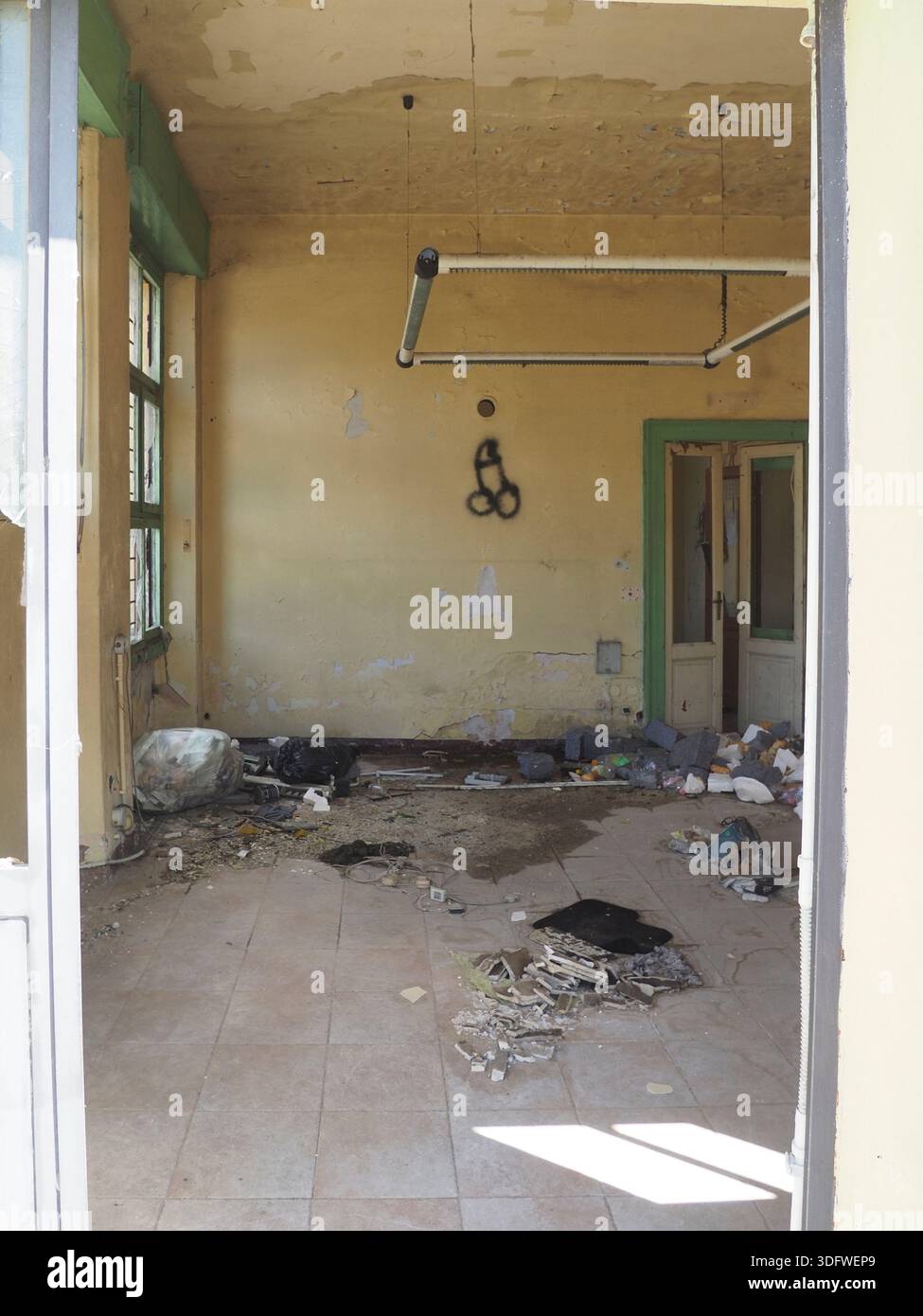 Abandoned room with trash and debris scattered on the floor, giving a ...