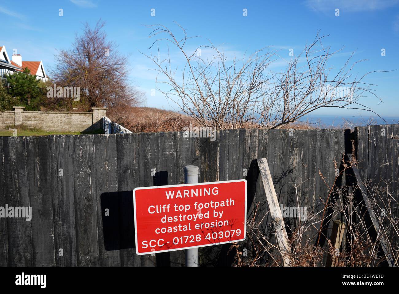 A sign warning that a footpath has been destroyed by coastal erosion in ...