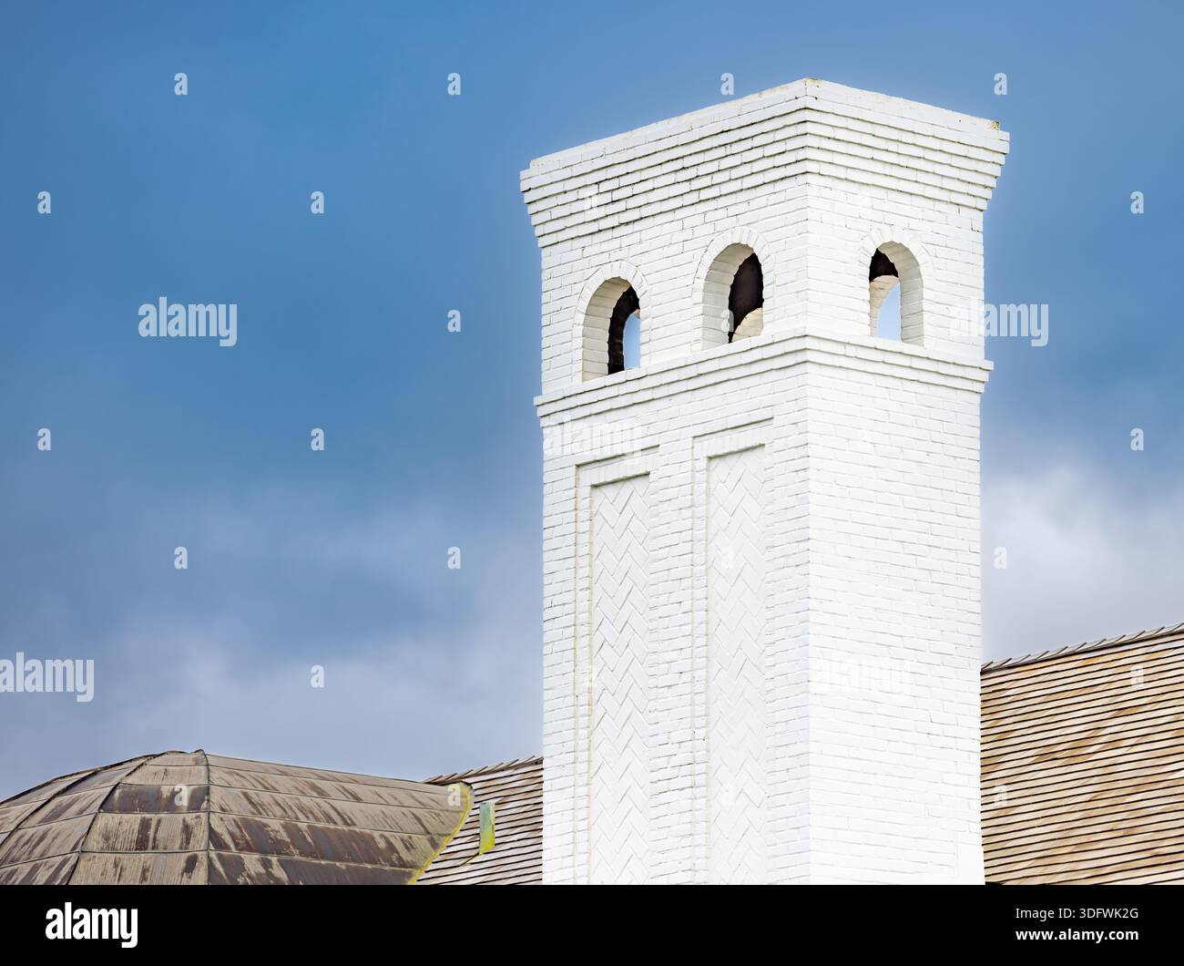 detail image of the top of a large white chimney with six arched ...