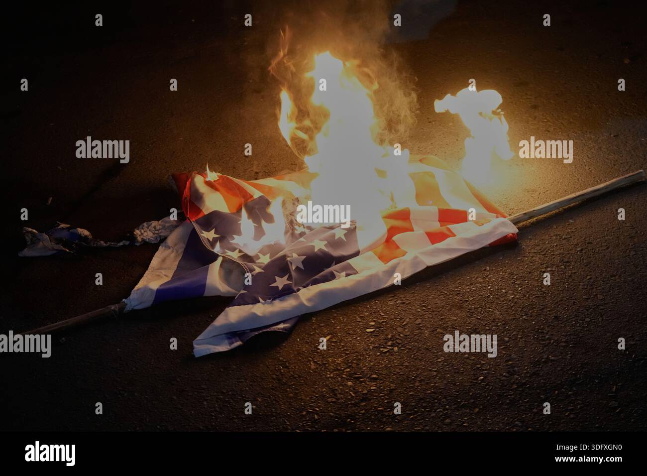 Representation of the U.S. and Israeli flags are set on fire during a ...