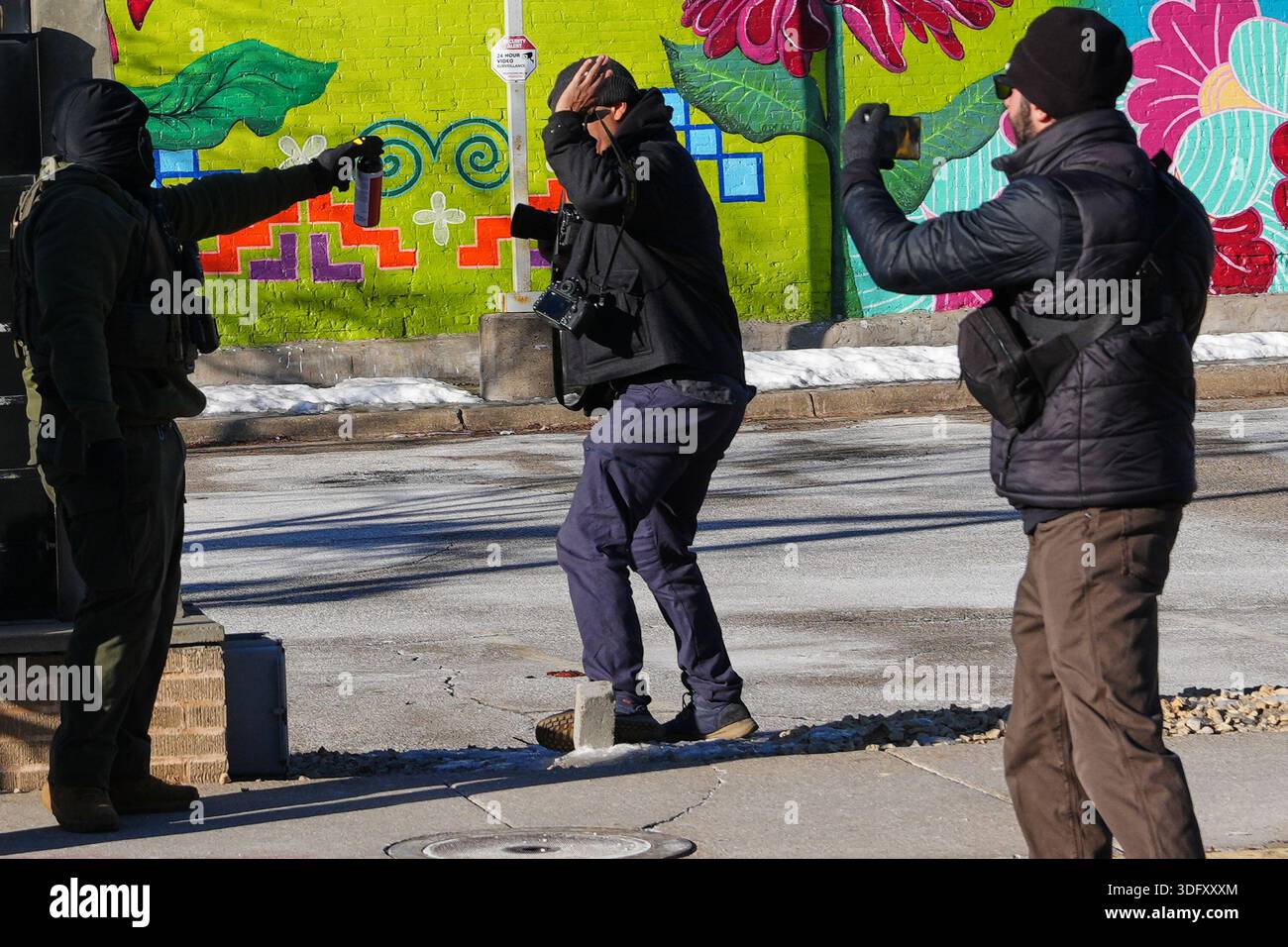 A federal immigration officers aims pepper spray at a journalist on ...
