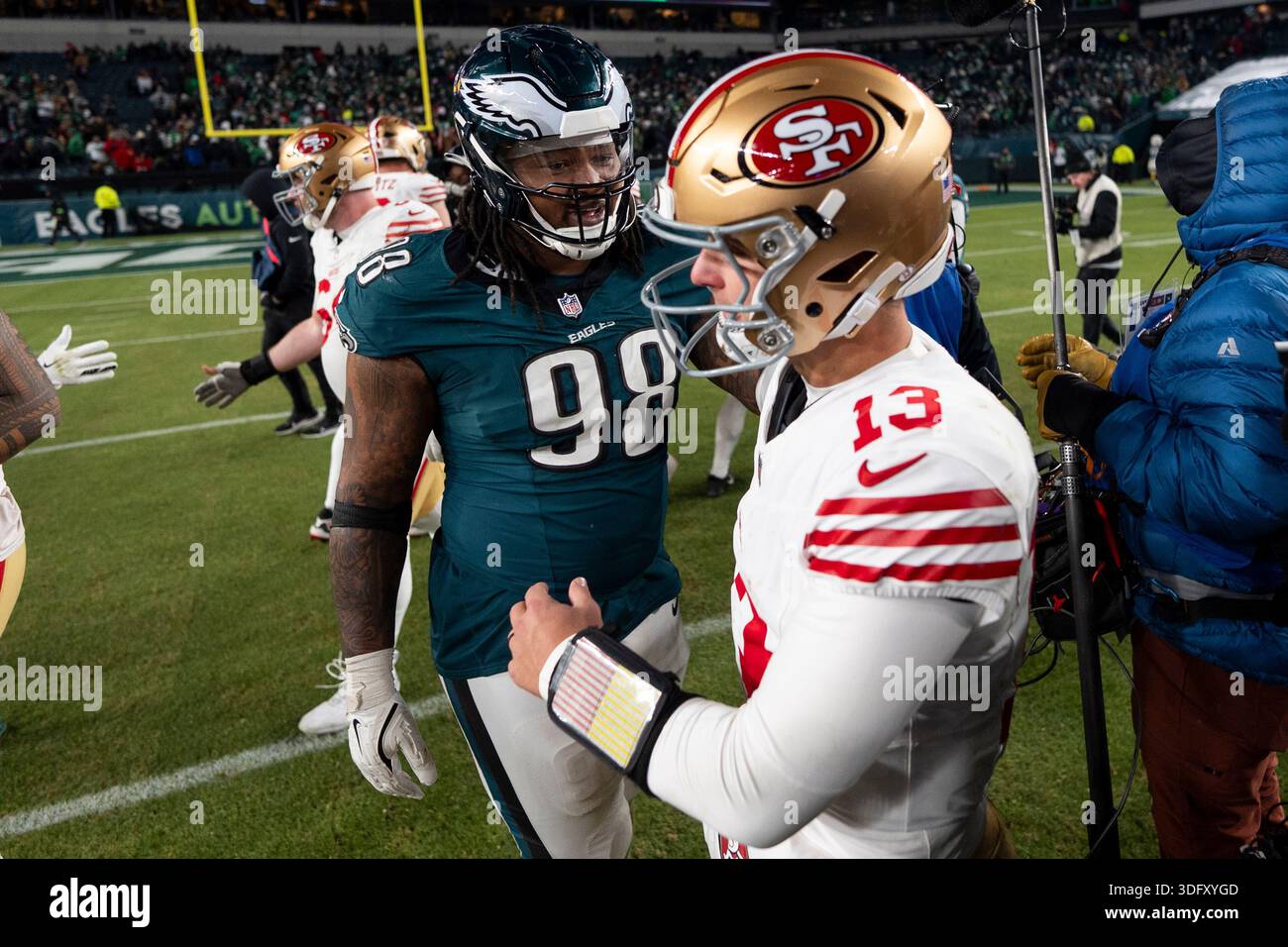 San Francisco 49ers quarterback Brock Purdy, right, talks with ...