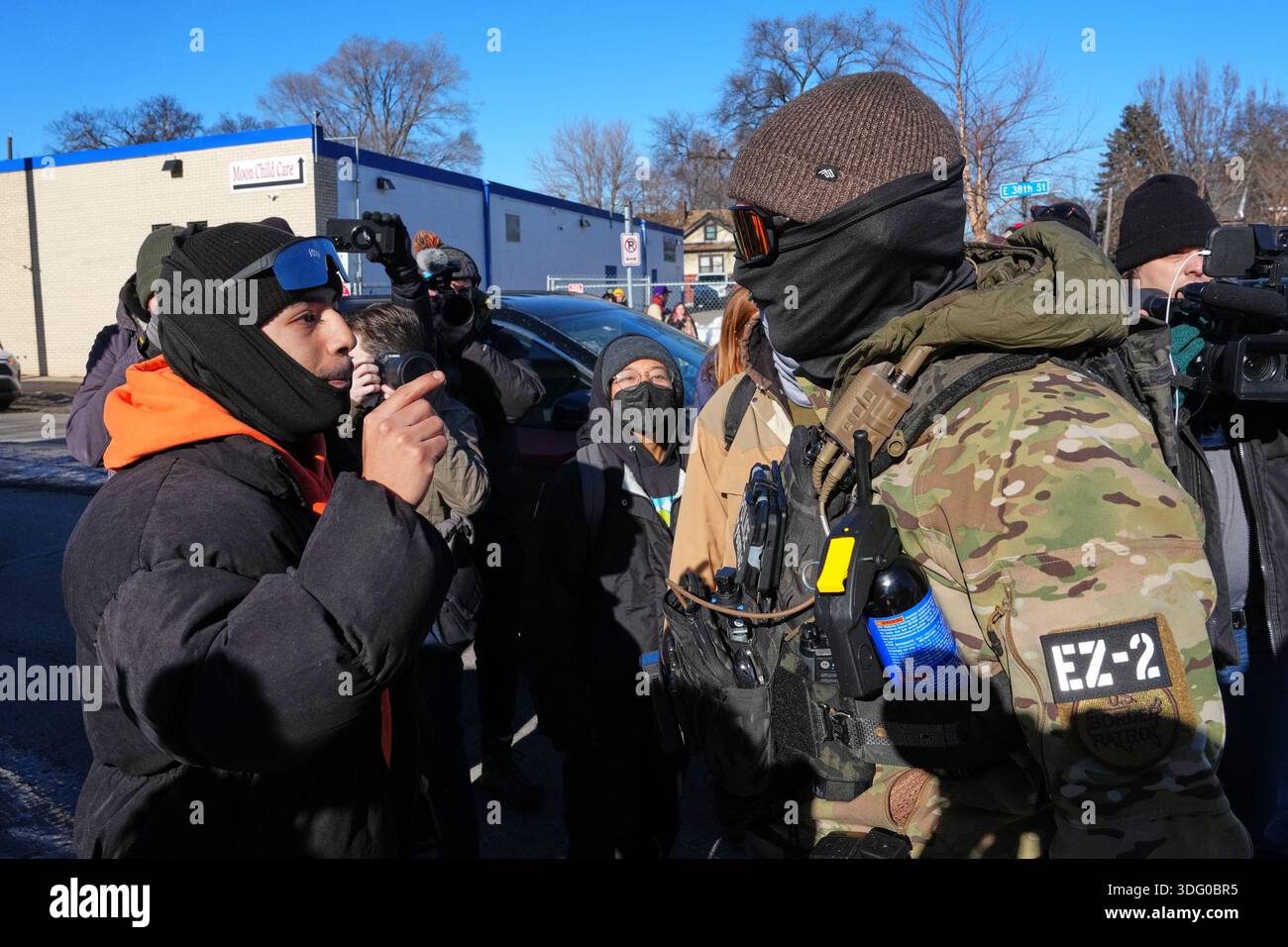 A person confronts a U.S. Border Patrol officer Wednesday, Jan. 14 ...