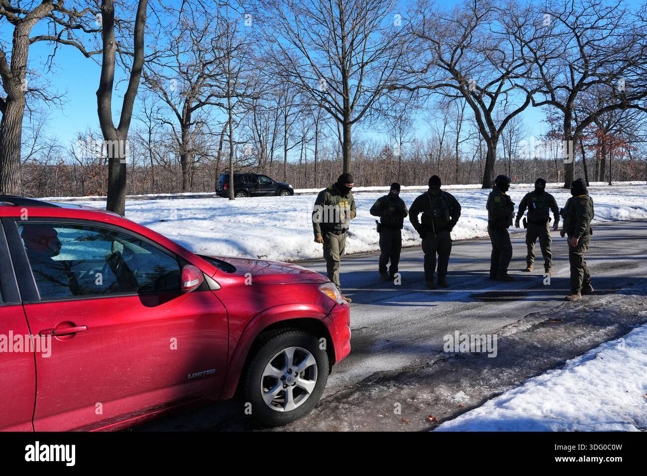 U.S. Border Patrol officers block the street Wednesday, Jan. 14, 2026 ...
