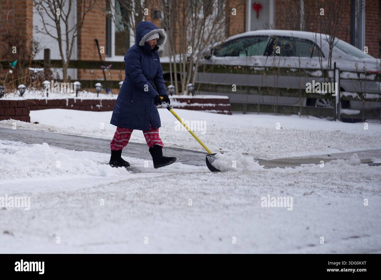 A person cleans snow during a cold day in Wheeling, Ill., Wednesday ...