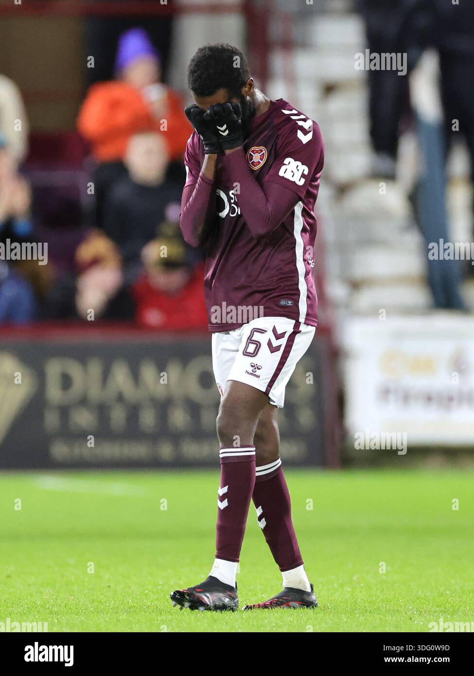 Heart of Midlothian's Beni Baningime reacts after being shown a red ...