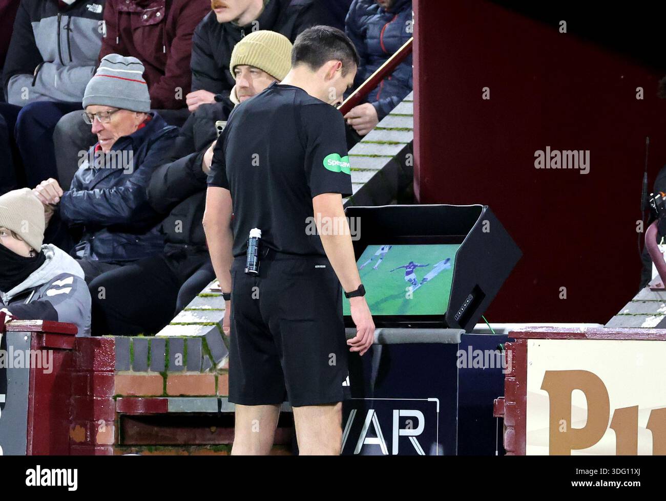 Referee Kevin Clancy consults the pitch side VAR before showing Heart ...