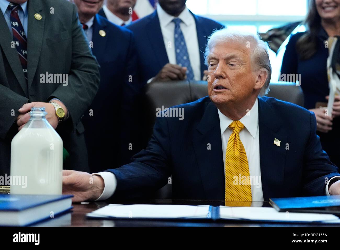 President Donald Trump touches a container of milk as he speaks in the ...