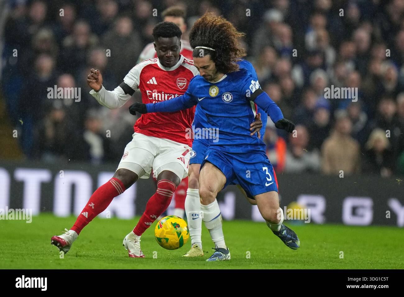 Arsenal's Bukayo Saka, left, vies for the ball with Chelsea's Marc ...