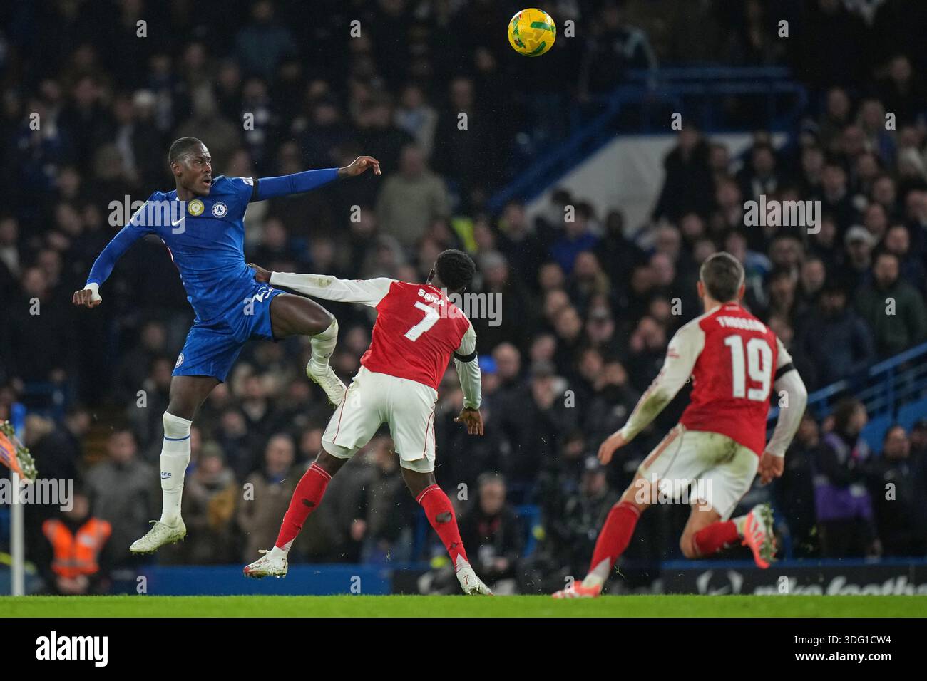 Chelsea's Trevoh Chalobah, left, is challenged by Arsenal's Bukayo Saka ...