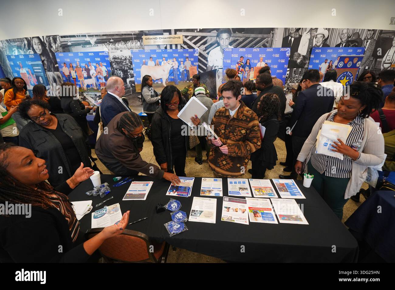 Job seekers listen for information on employment during a hiring fair ...